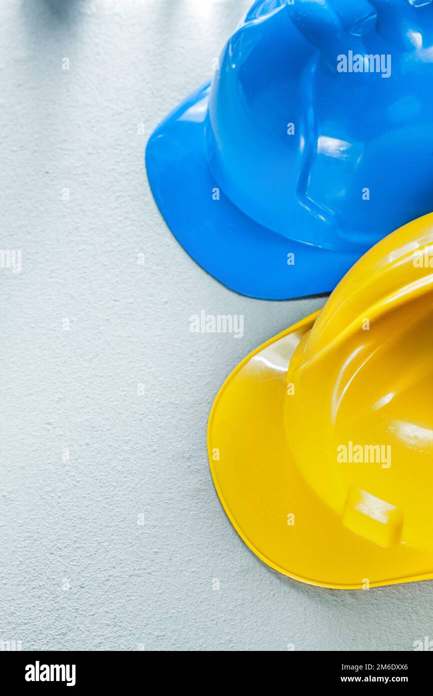 Protective building helmets on concrete background Stock Photo - Alamy