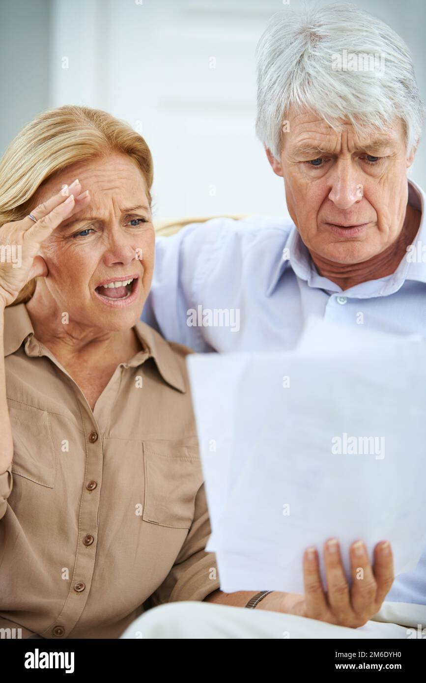 Worried elderly looking at paperwork hi-res stock photography and ...