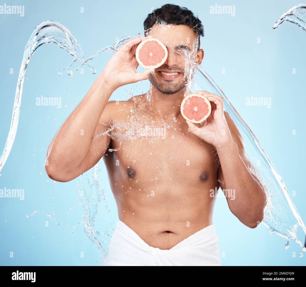 Skincare, beauty and water splash, man with fruit for vitamin c facial ...