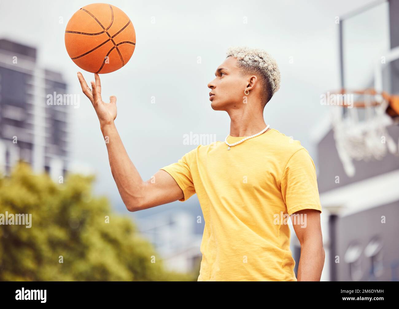Sports, fitness and man spinning basketball on court outdoors before ...