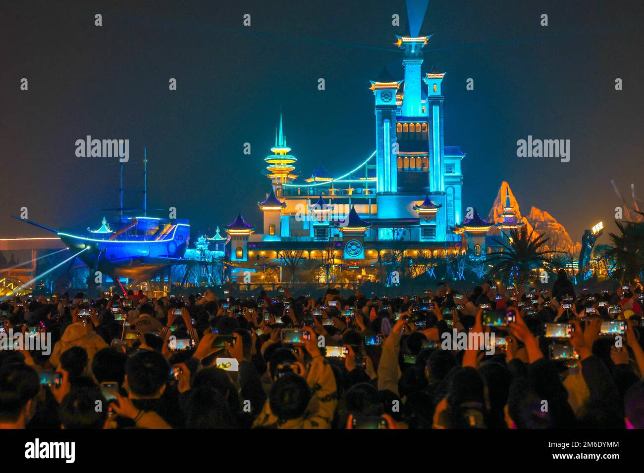 Tourists watch the New Year fireworks light show in Overseas Chinese ...