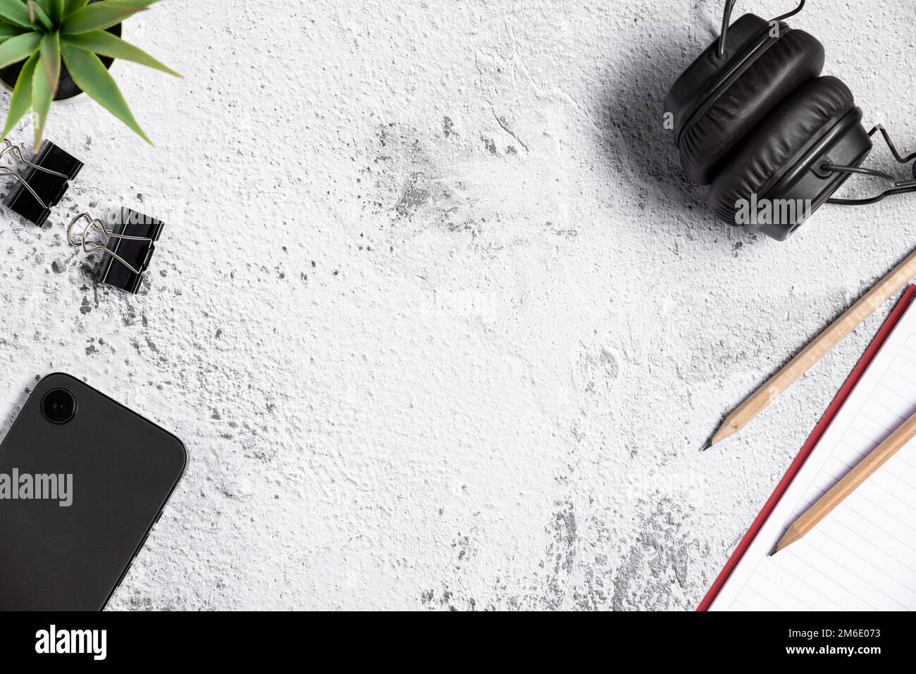 Top view of flat lay table composition with smartphone, pen, notepad ...