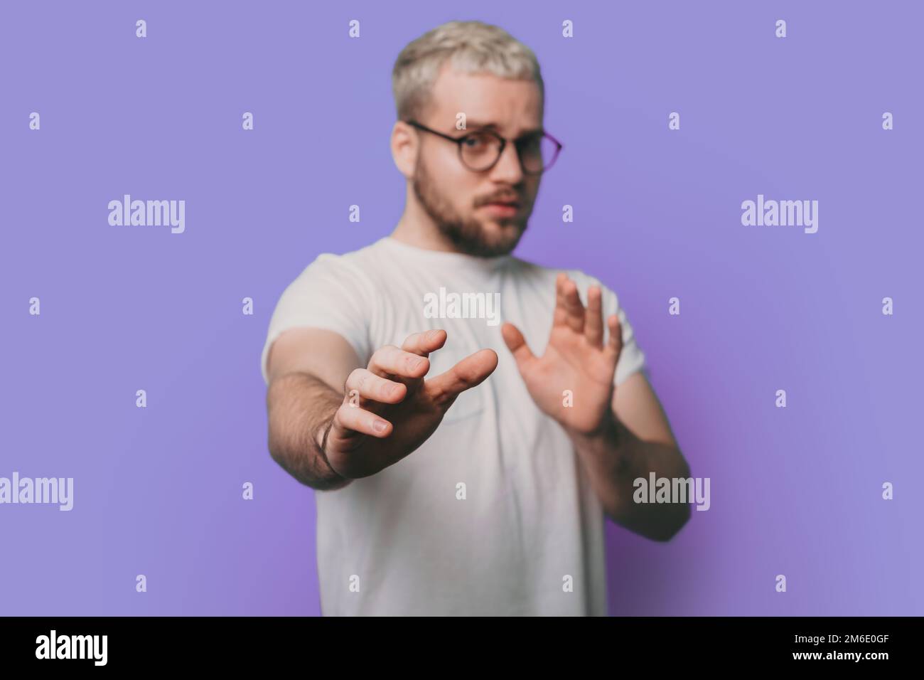 Caucasian man wearing eyeglasses doing disgust expression because ...