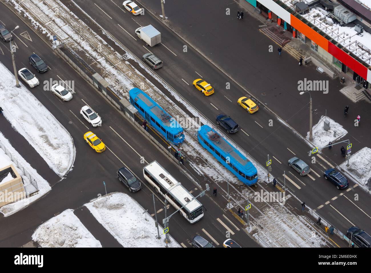 City crossroads with various vehicles, trams and buses, cars and ...