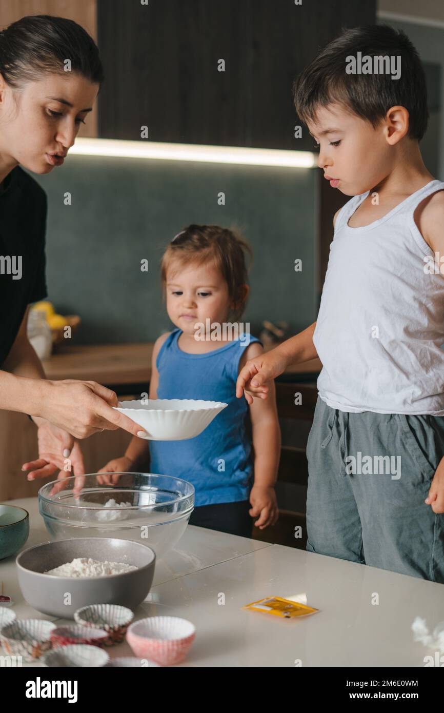 Woman teaching child prepare dough hi-res stock photography and images ...