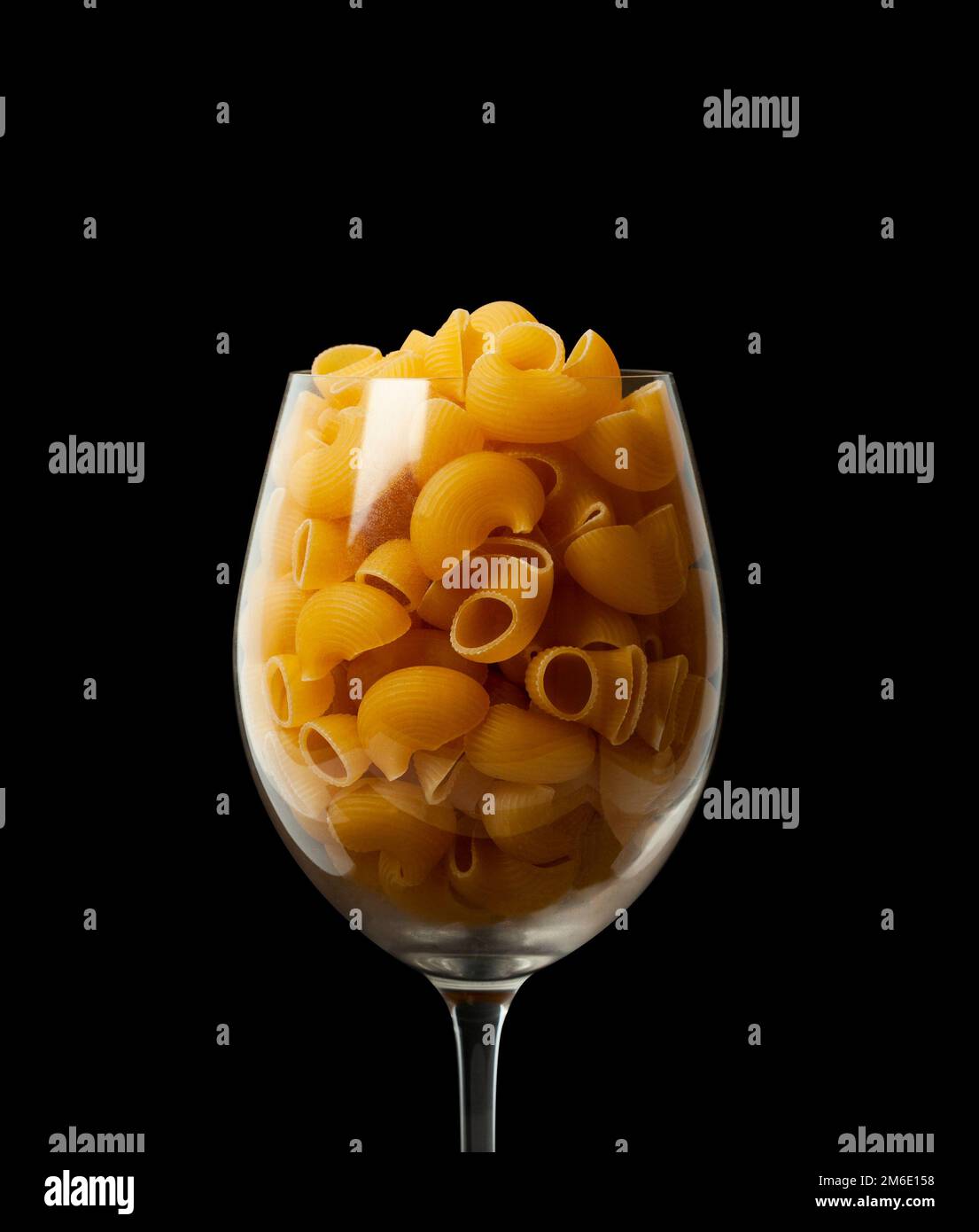 Pasta Pipe Rigate in a glass cup isolated on black background Stock ...