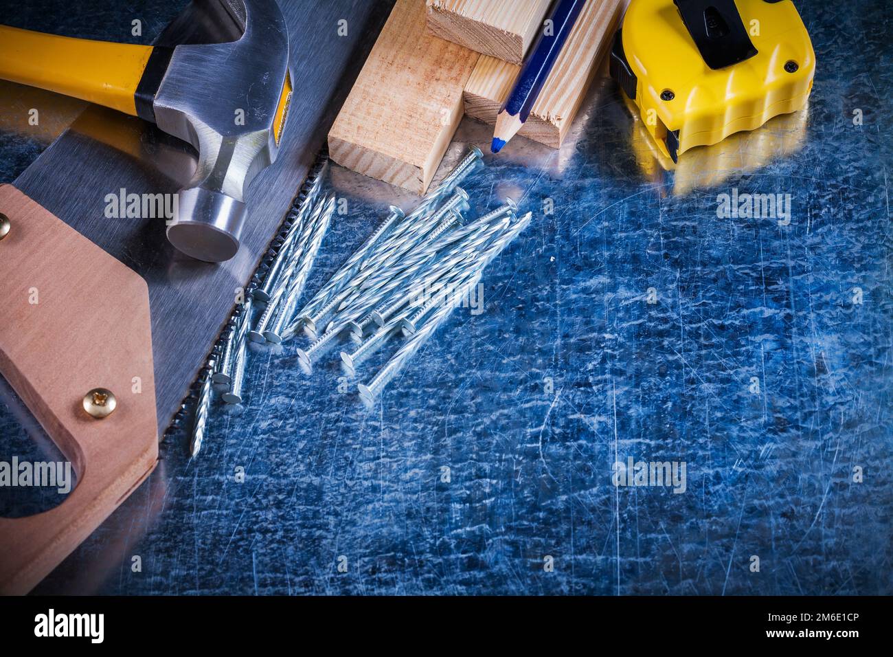 Construction nails hammer wooden bricks hand saw pencil and tape-line ...