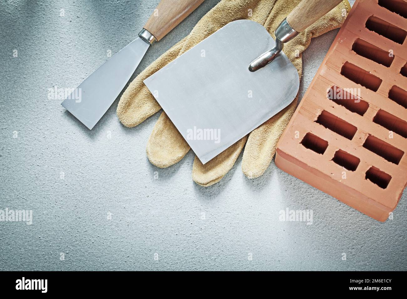 Construction brick leather protective gloves putty knives on concrete ...