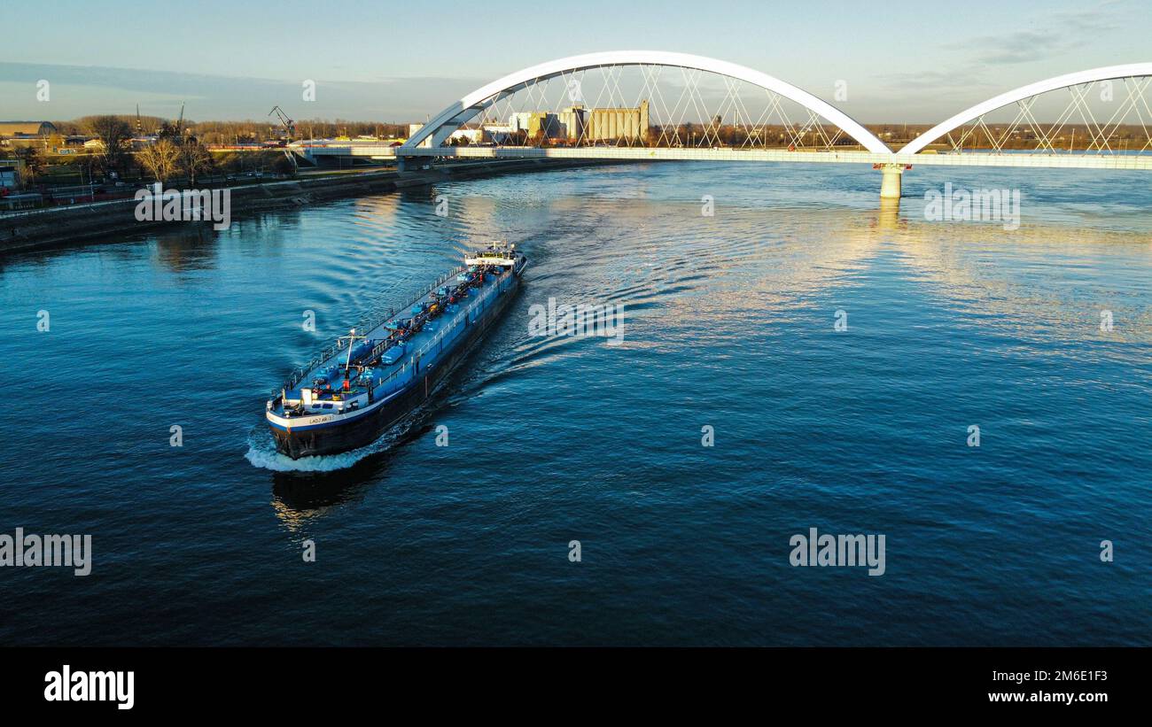 A landscape of a tour boat in Danube river by Pont de zezelj Tied-arch ...