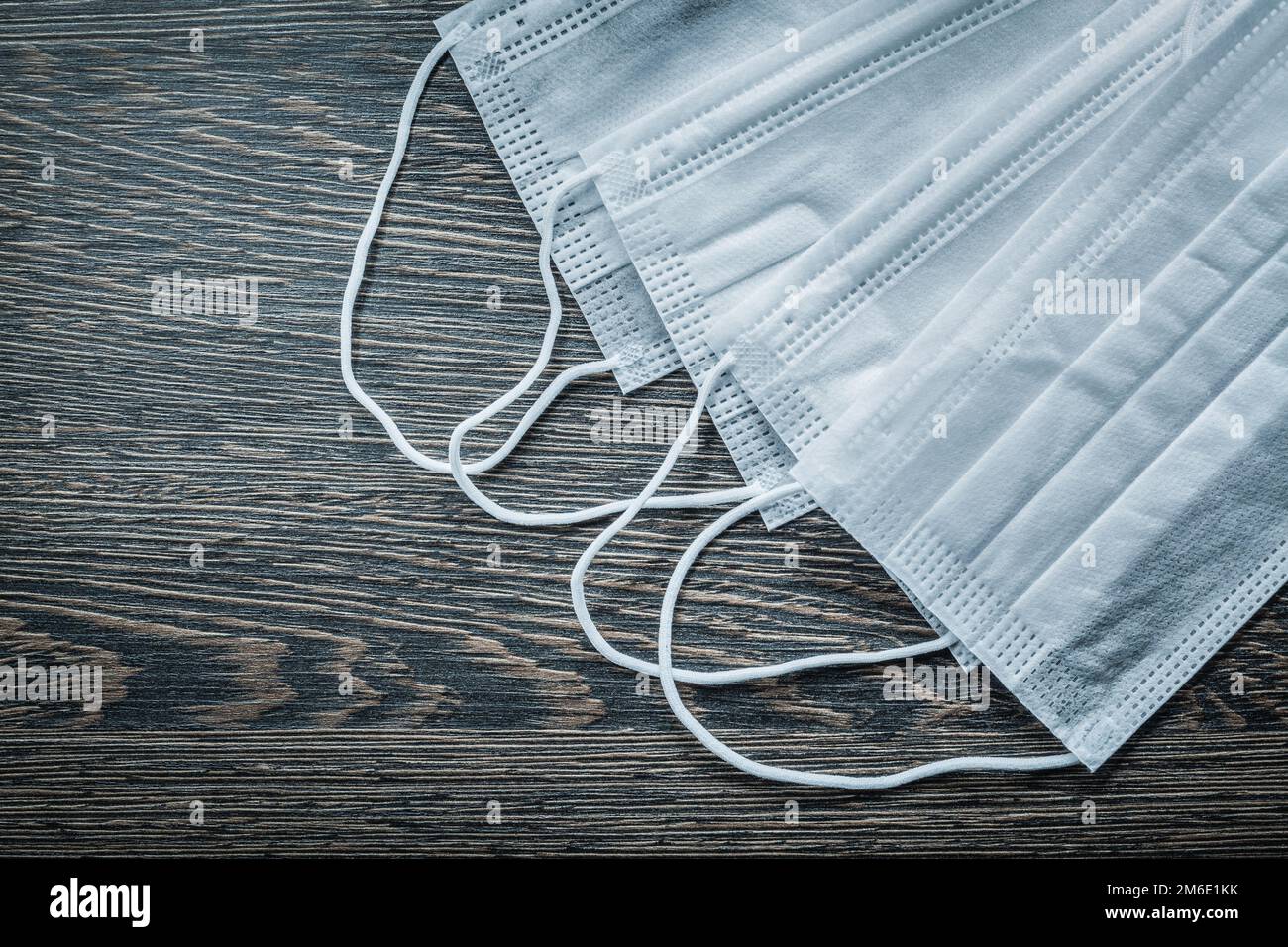 Disposable surgical masks on vintage wooden board Stock Photo - Alamy
