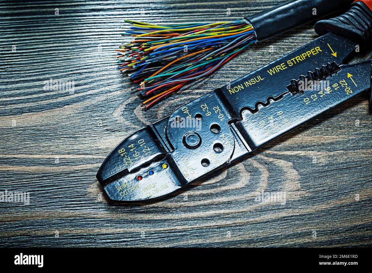 Electric wires insulated stripper on wooden board Stock Photo - Alamy