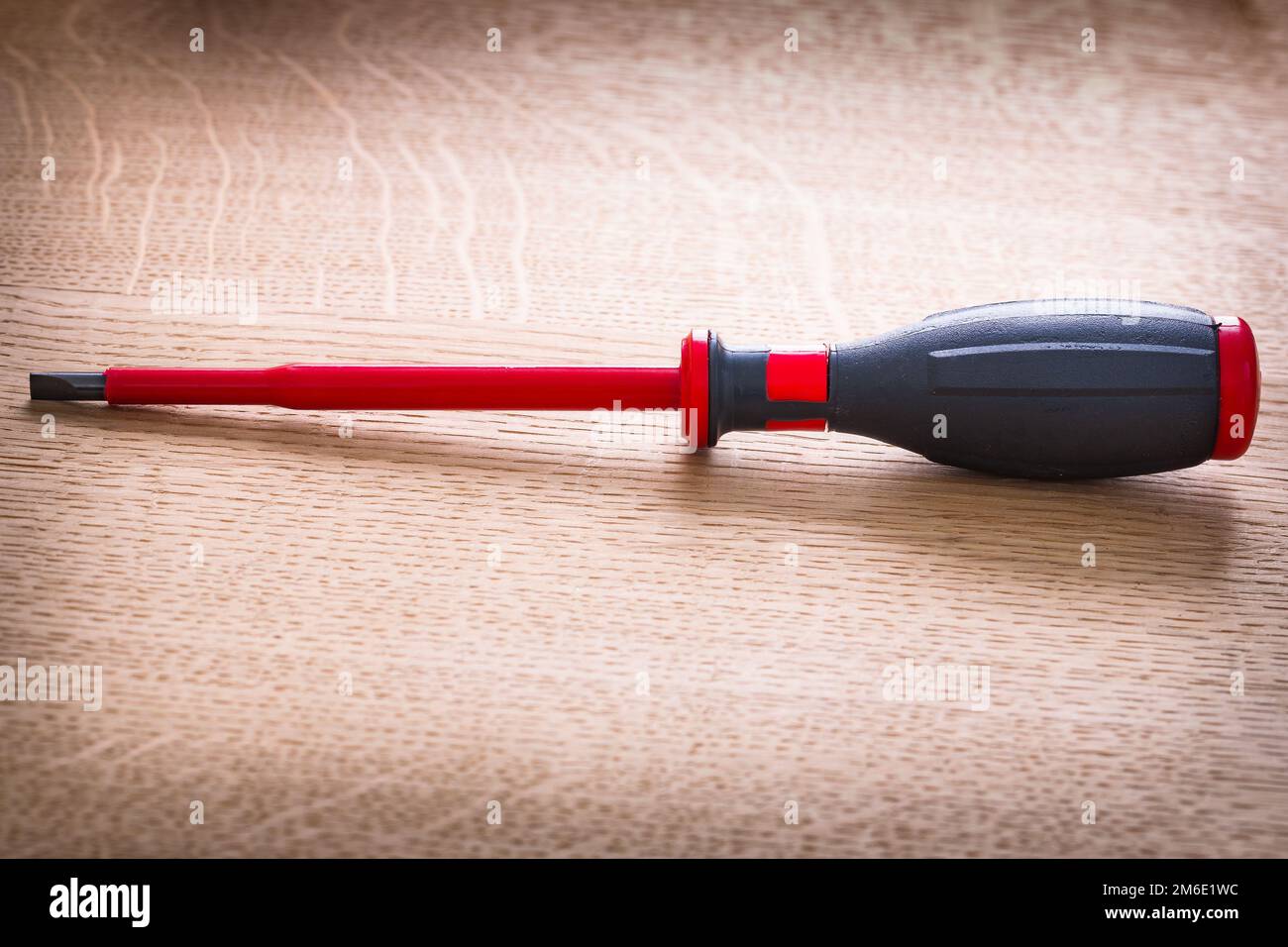 electric insulated red screwdriver on wooden board Stock Photo - Alamy