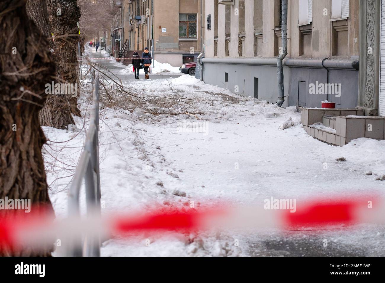 Blocked passage. A red ribbon blocks the path. Snow removal in spring ...