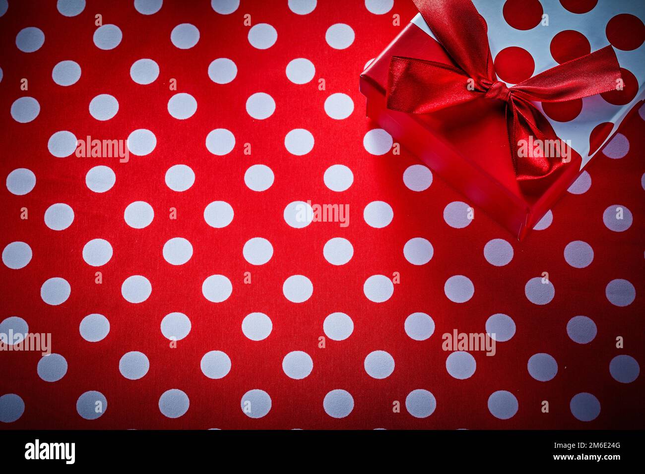 Gift box on polka-dot red table cloth holidays concept Stock Photo - Alamy