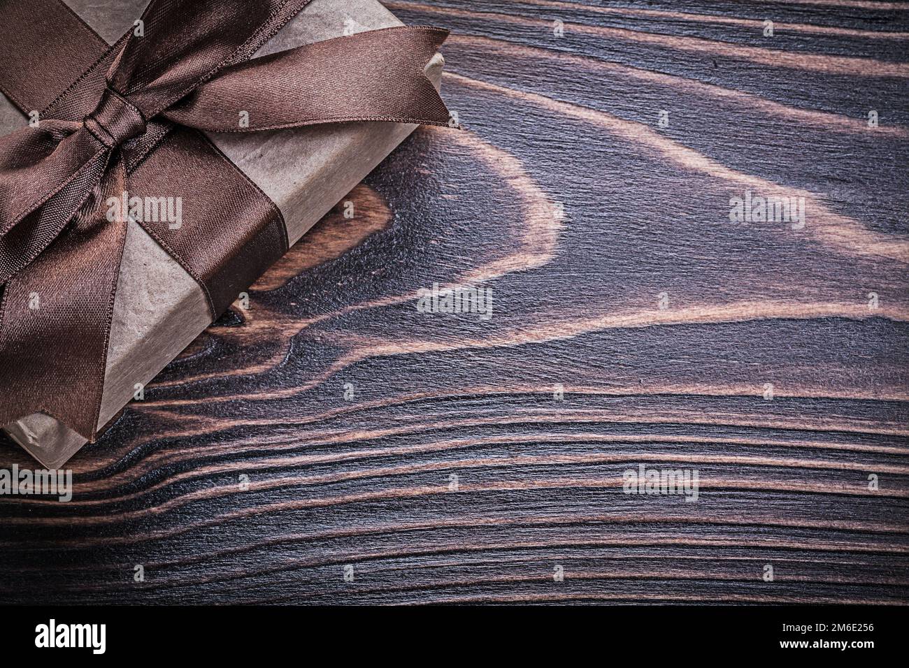 Giftbox with brown present tape on wood board holidays concept Stock ...