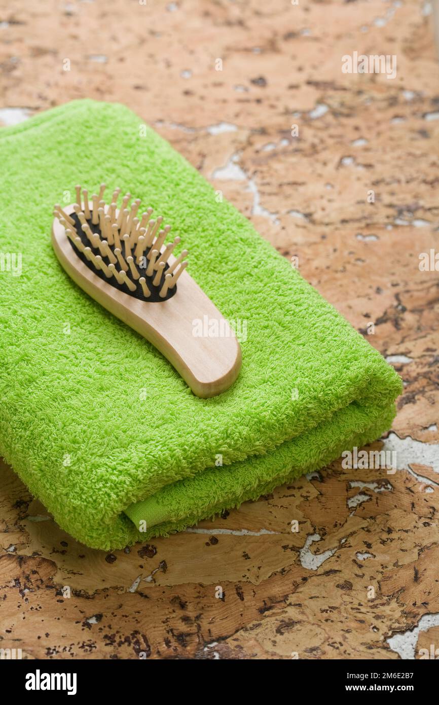 hairbrush on green towel Stock Photo - Alamy