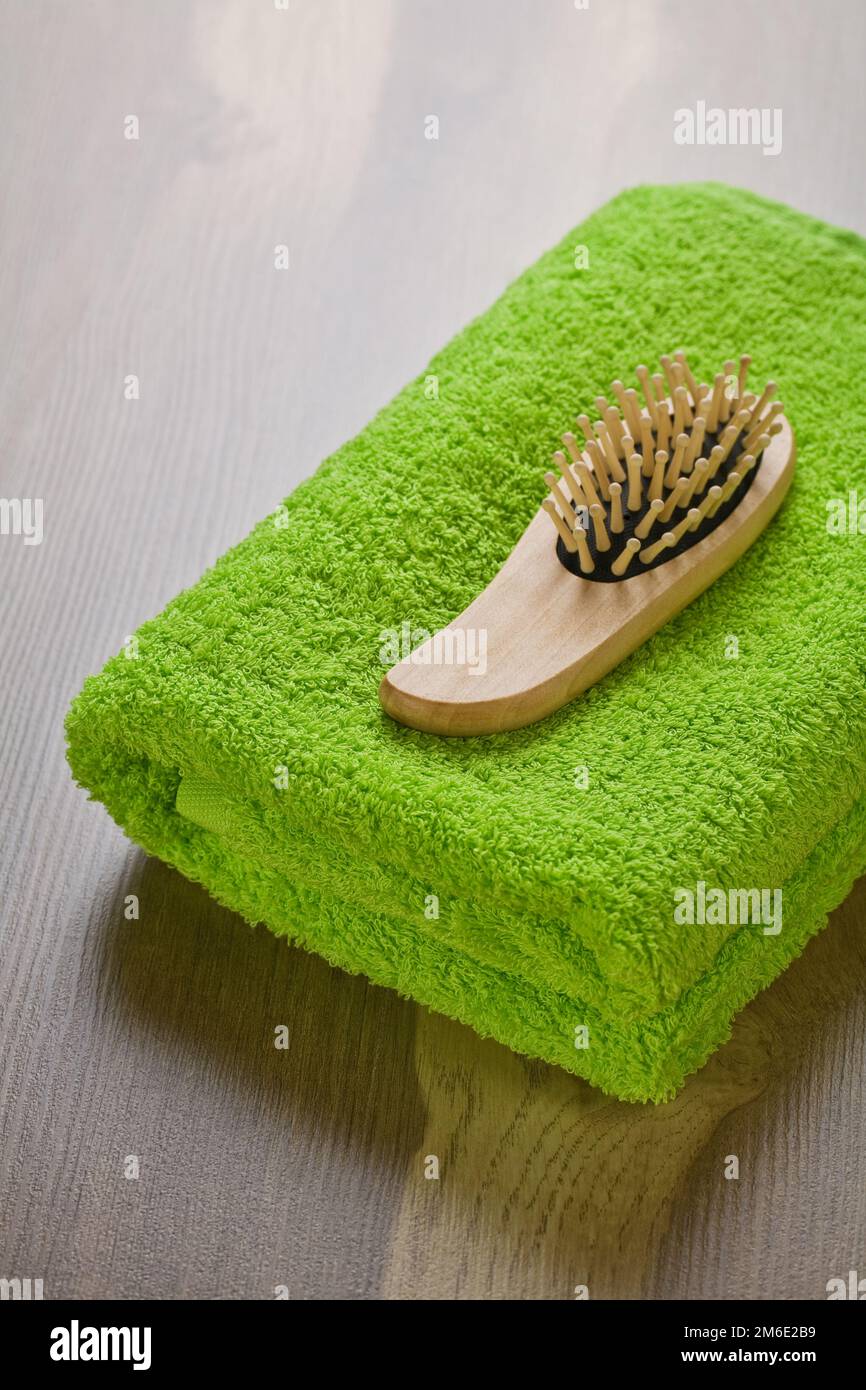 hairbrush on green towel Stock Photo - Alamy