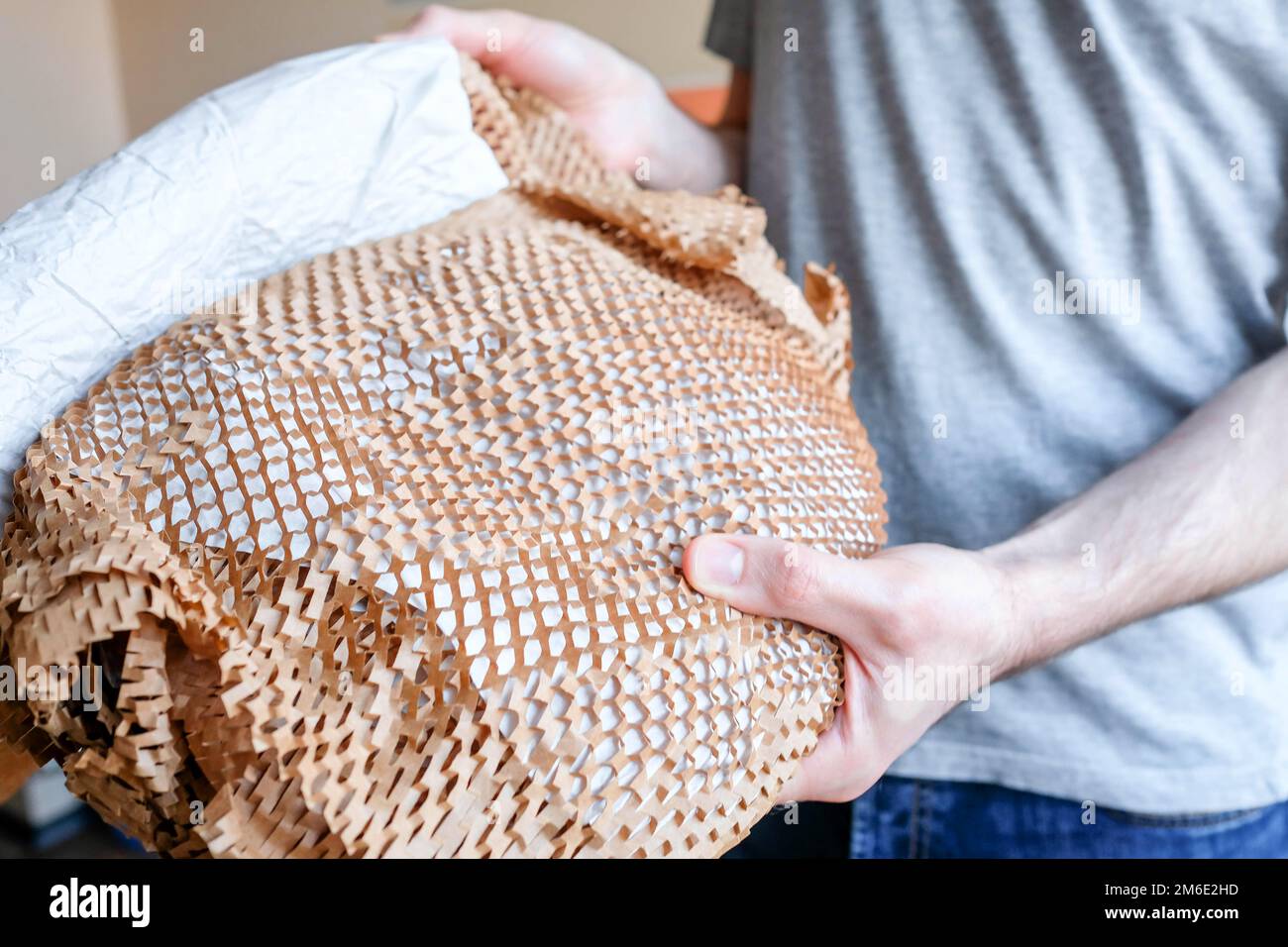 Hold a packaged fragile item. Paper packaging in the form of a grid ...