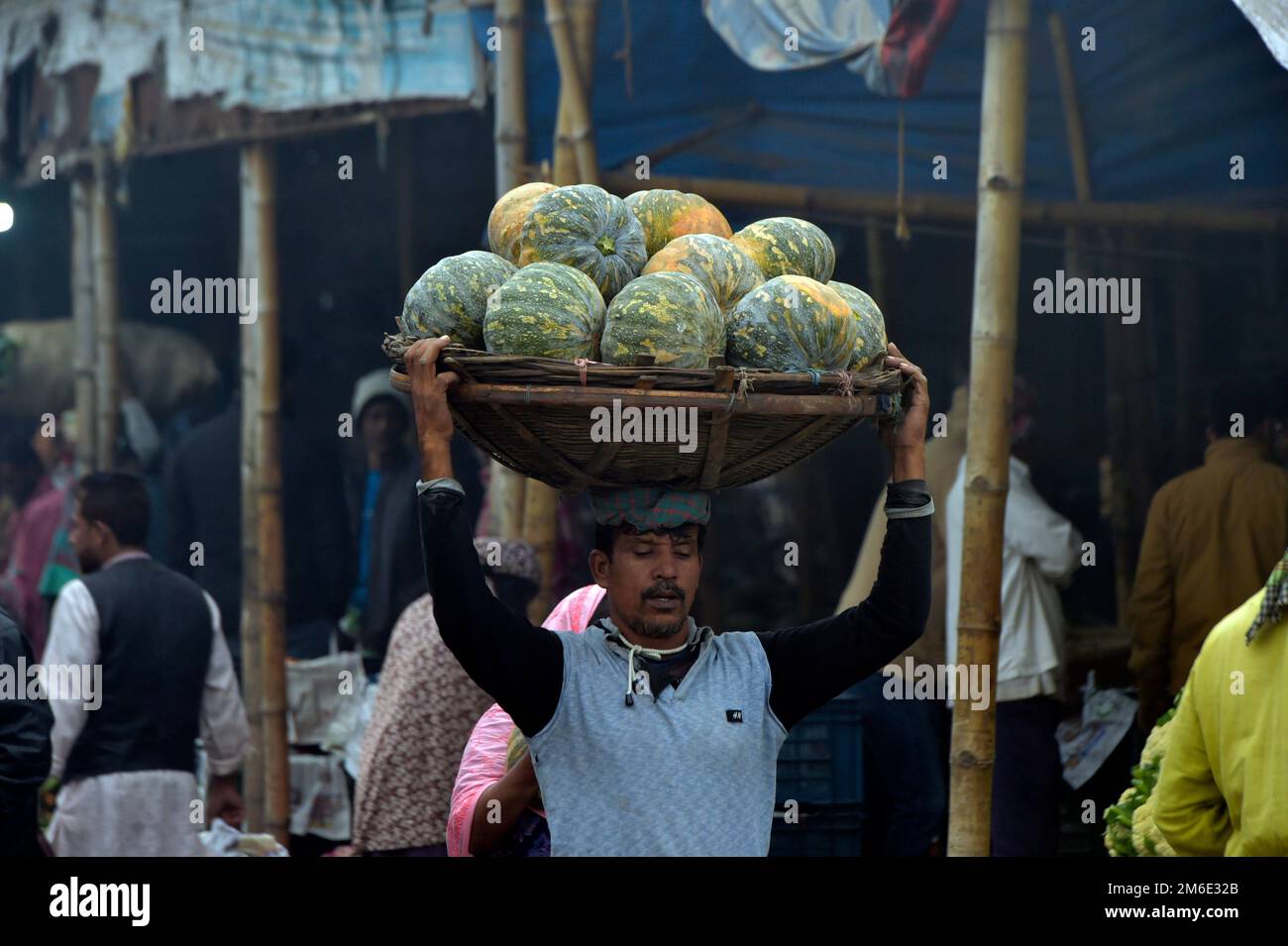 Dhaka. 4th Jan, 2023. A man carries a basket of freshly harvested ...