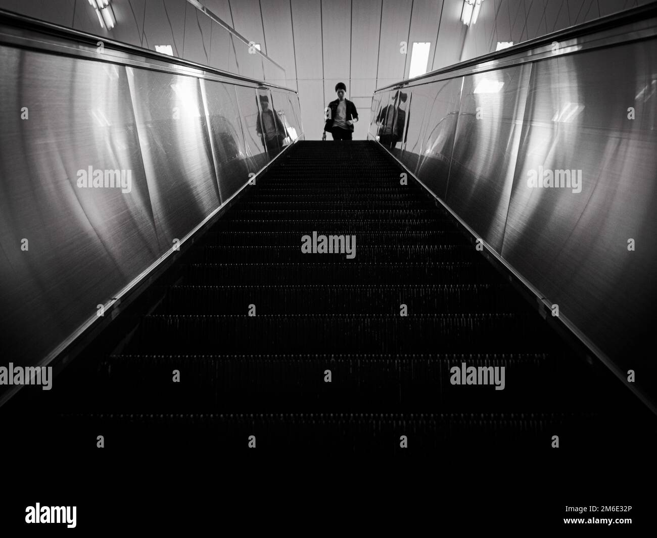 Tokyo, Japan - 17 11 19: A man about to start walking down an escalator ...