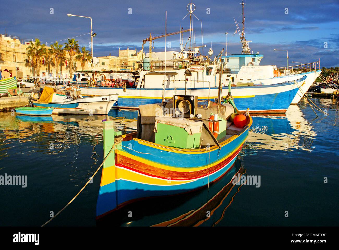 Traditional fishing boats luzzu in Marsaxlokk village in Malta, painted ...