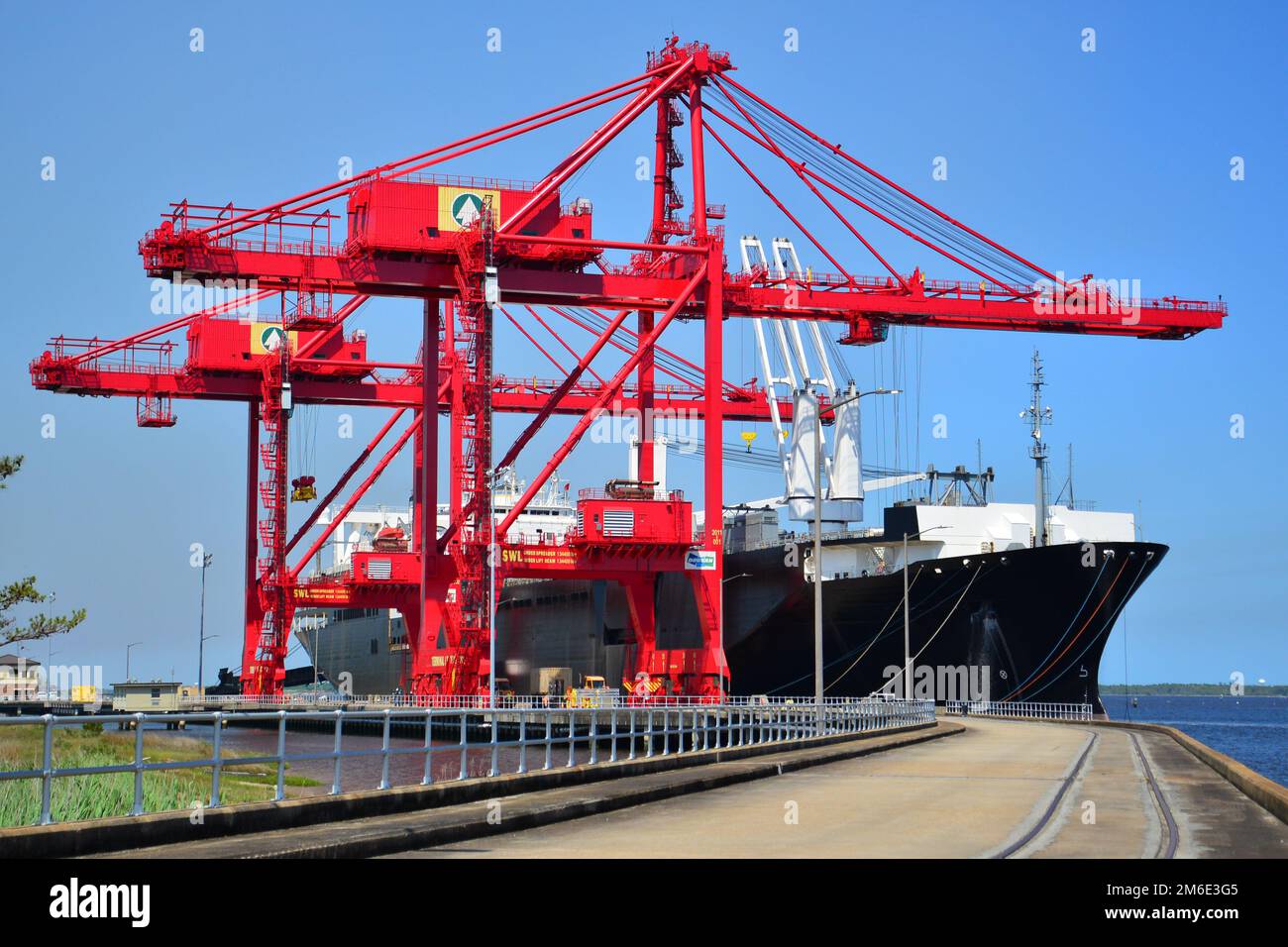 A cargo vessel prepares for ammunition loading on the wharf at Military ...