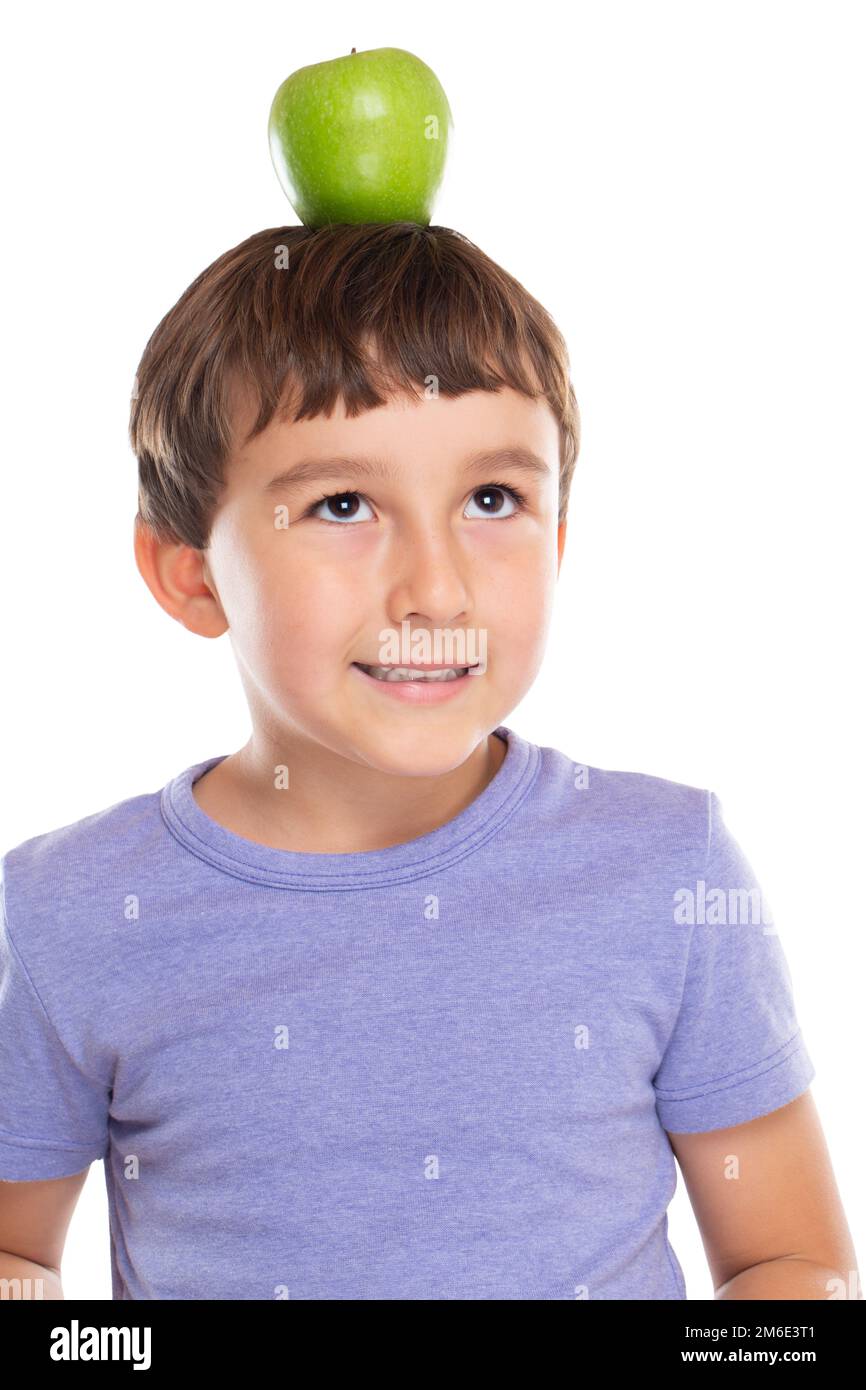 Young boy child with an apple fruit on his head healthy eating isolated ...