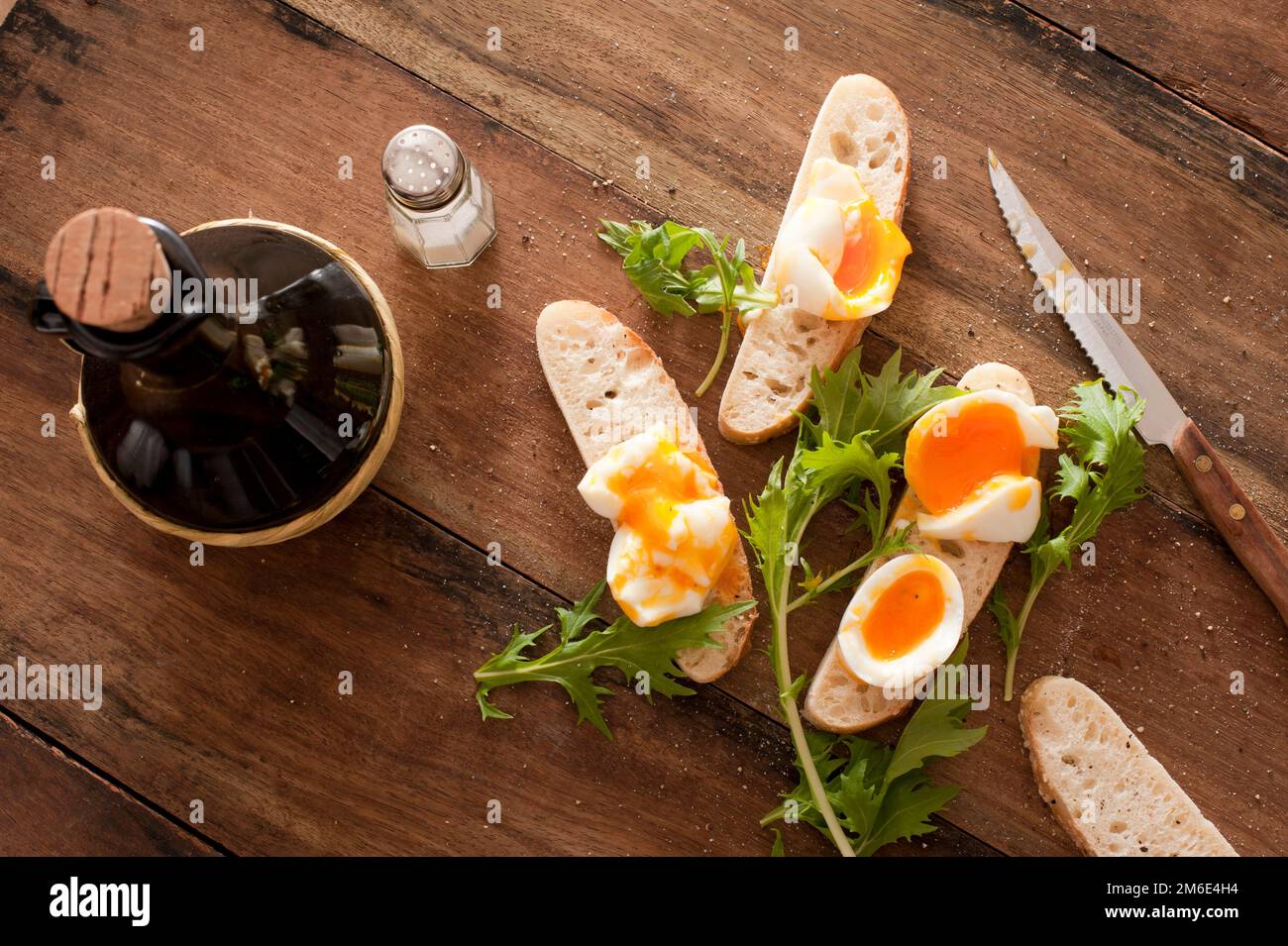 Snack of hard boiled eggs and herbs on baguette Stock Photo - Alamy