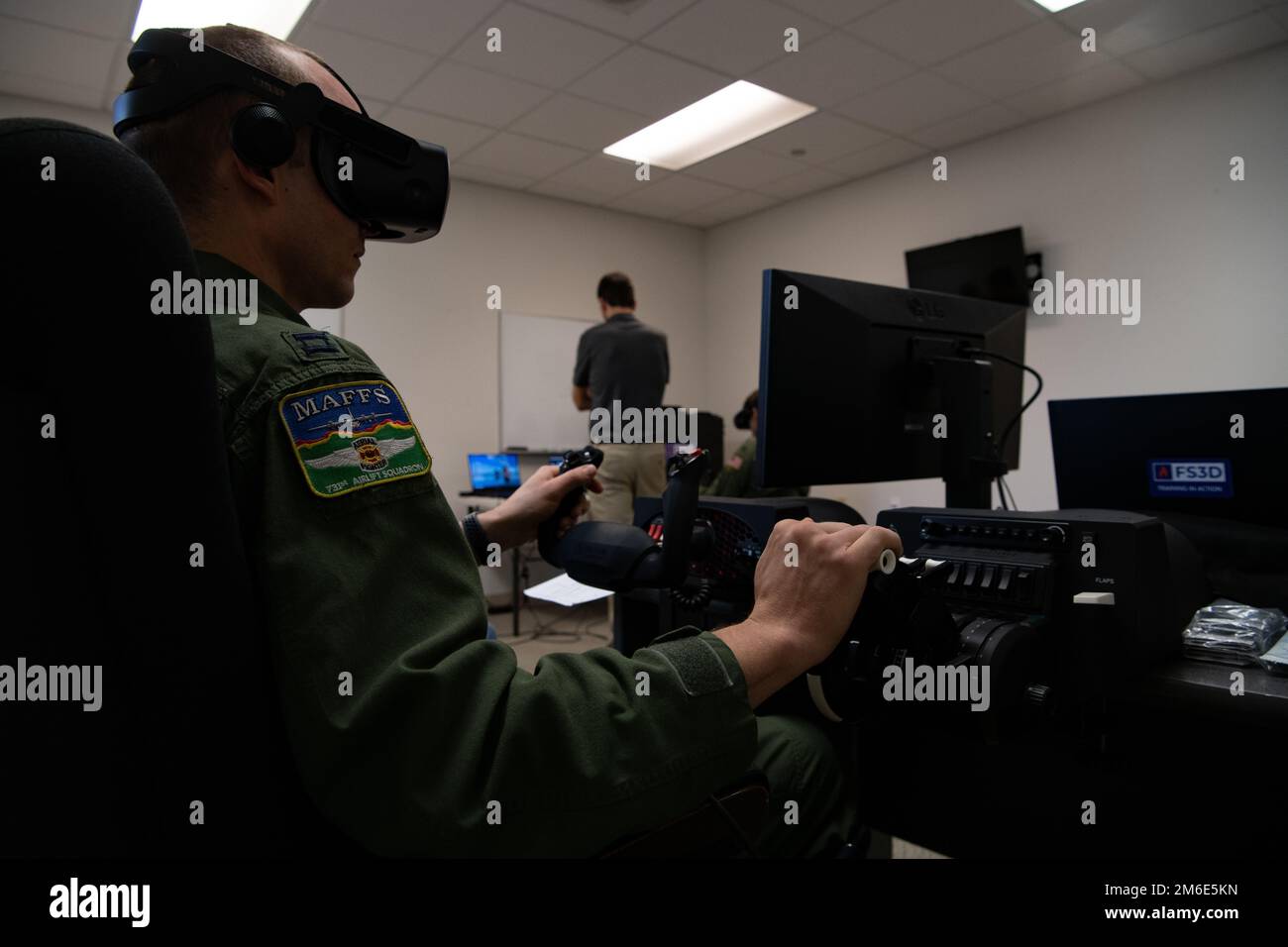 Capt. Erik Anonsen, 731st Airlift Squadron pilot, handles the controls ...