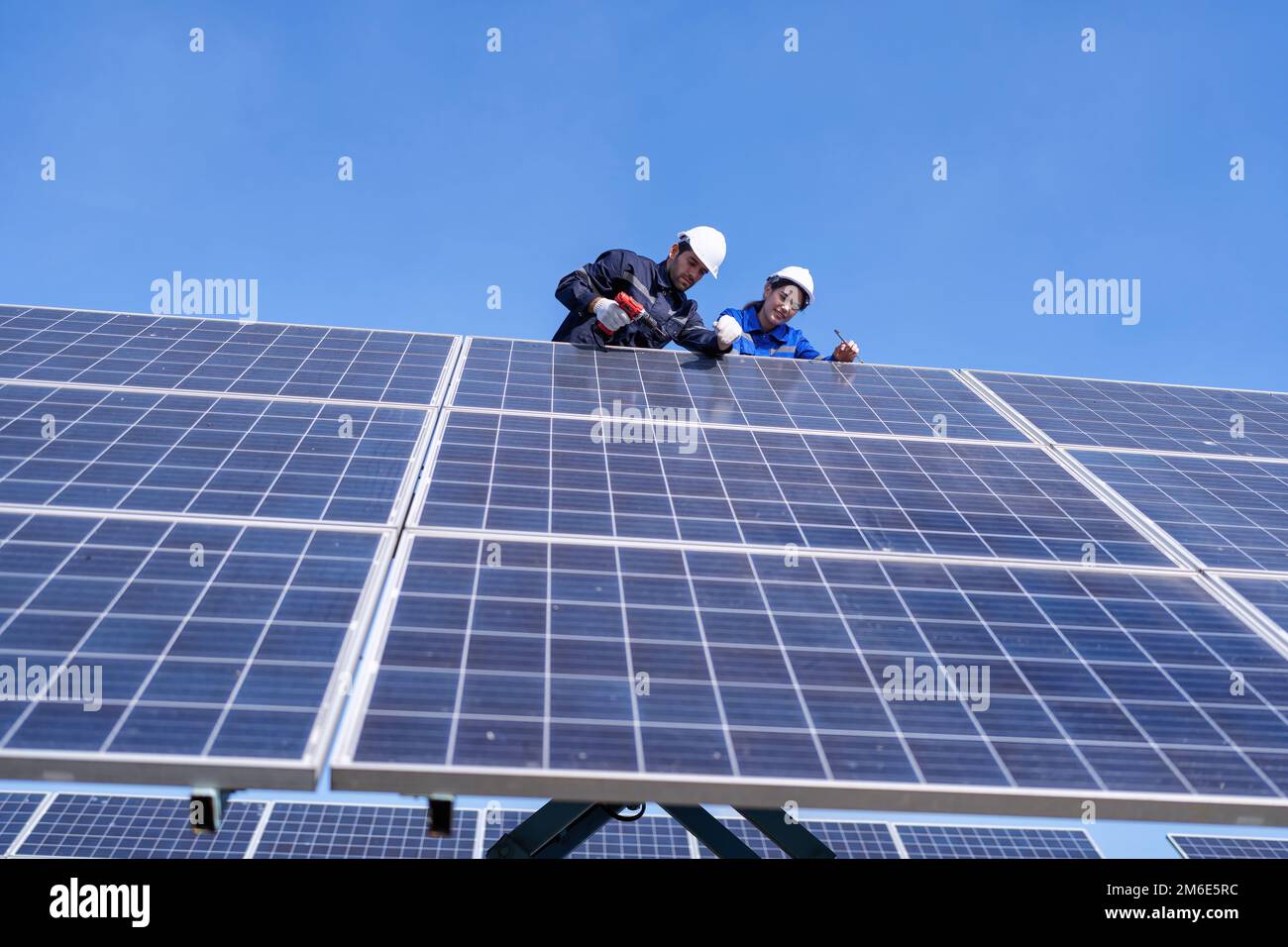 Maintenance engineer at solar farm stand on scissor lift inspection ...