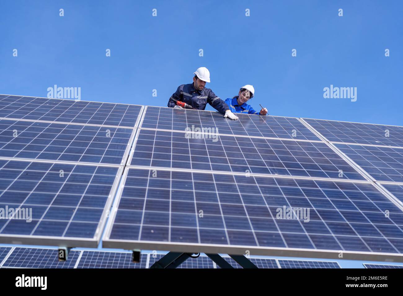 Maintenance engineer at solar farm stand on scissor lift inspection ...
