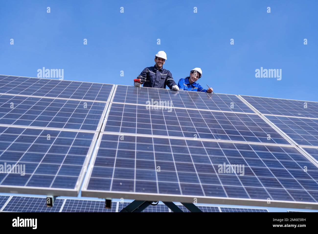Maintenance engineer at solar farm stand on scissor lift inspection ...