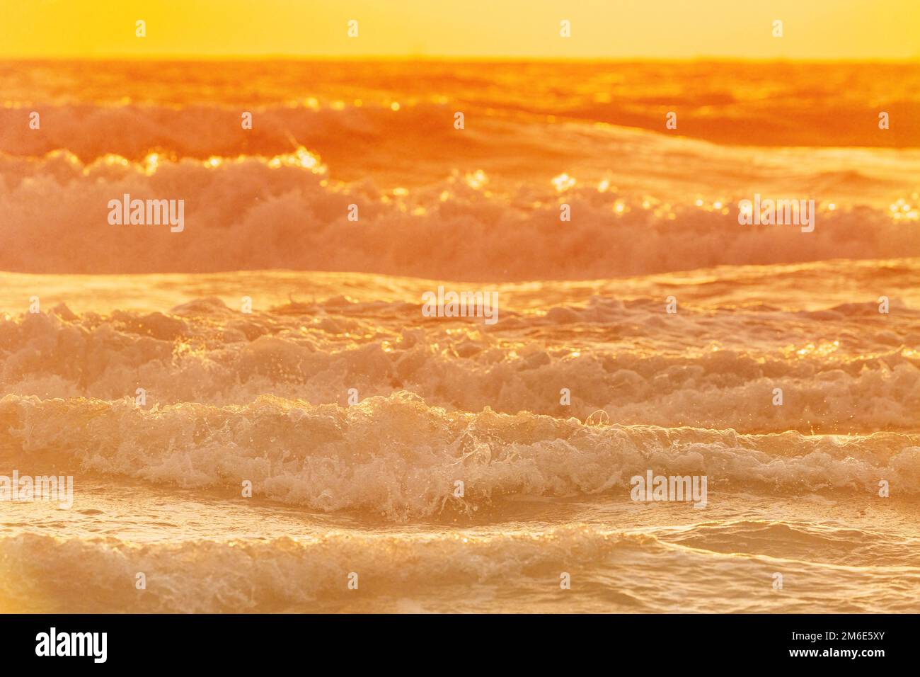 Evening sunset above sea. Riplpe sea ocean water surface with small ...