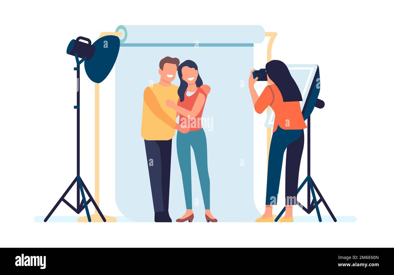 Photographer takes pictures of posing happy couple. Photo studio with ...