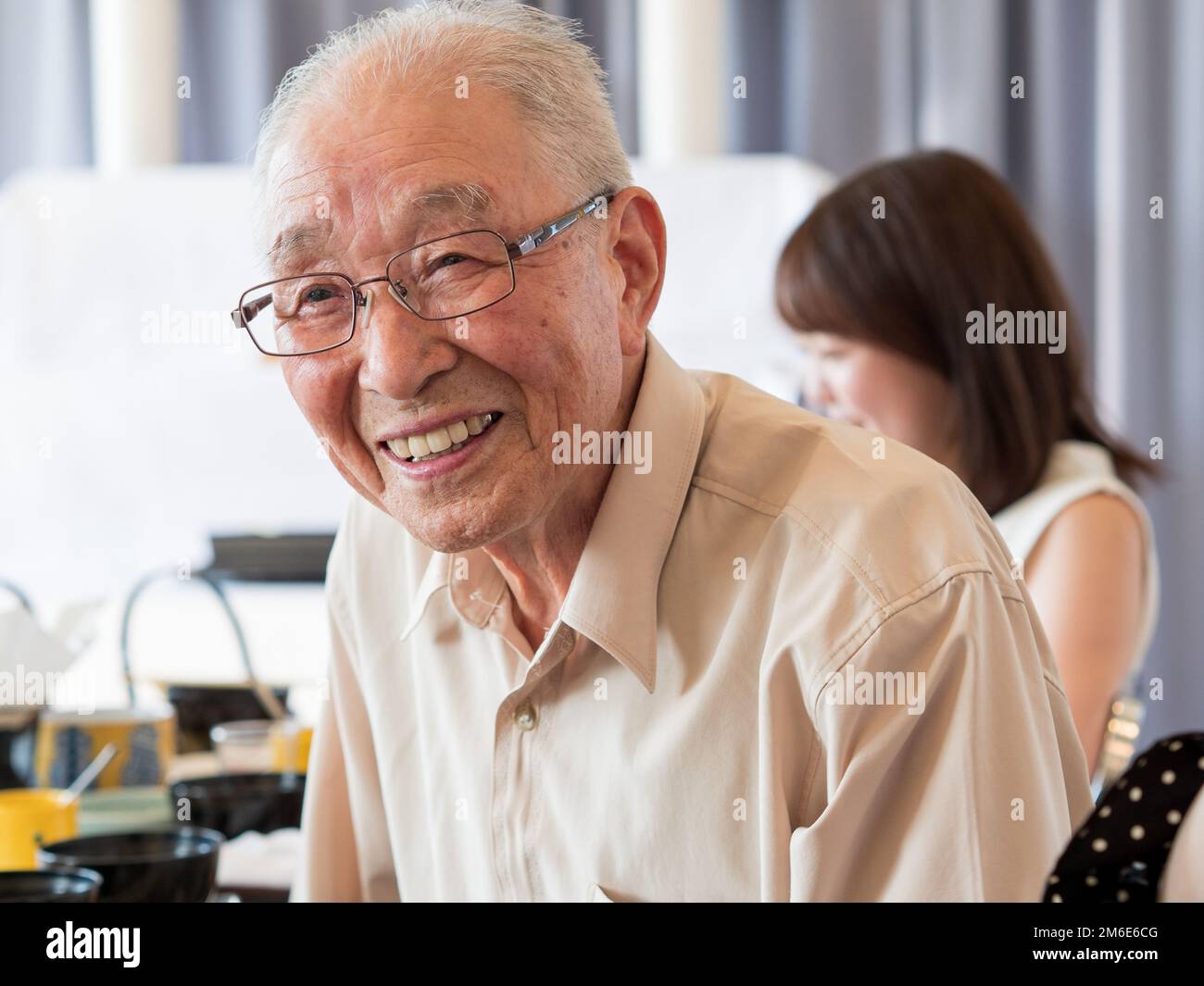 An old man talking animatedly at a family event Stock Photo - Alamy