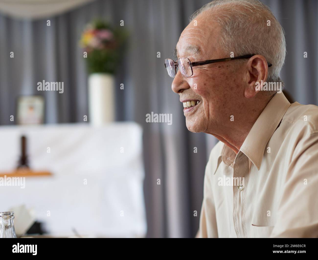 An old man talking animatedly at a family event Stock Photo - Alamy