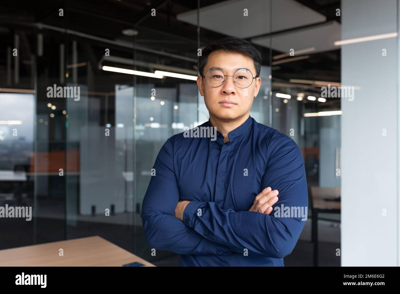 Portrait of asian businessman inside modern office, boss in glasses ...