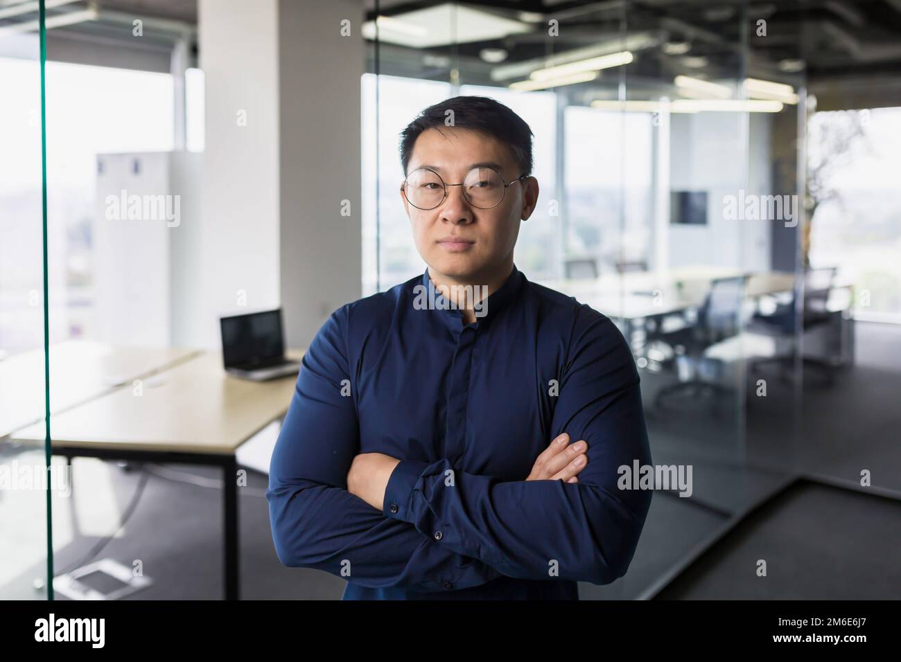 Portrait of asian businessman inside modern office, boss in glasses ...