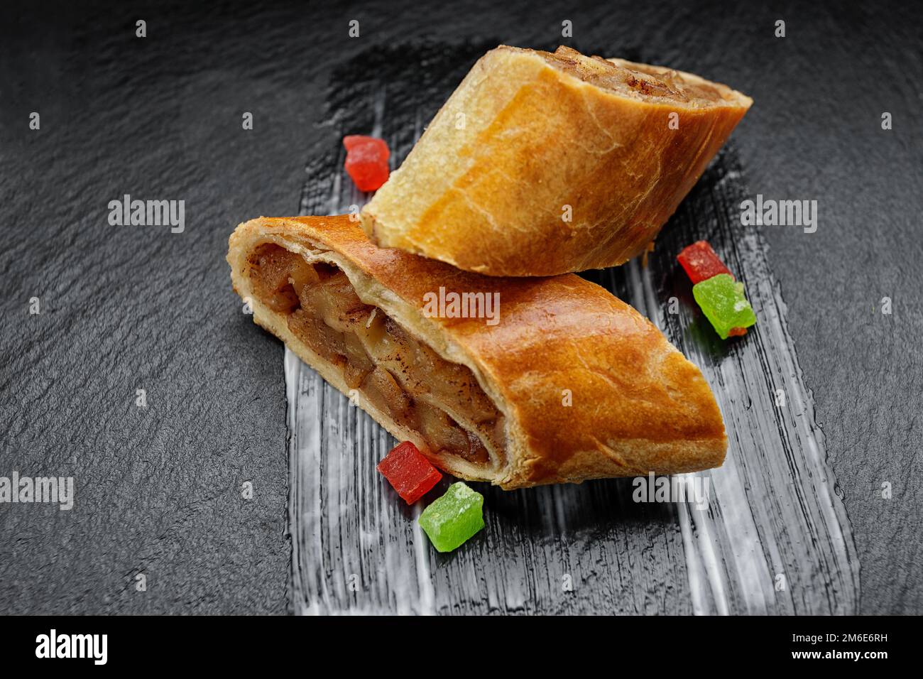 Baked Viennese strudel with an apple, on a black stone Stock Photo - Alamy