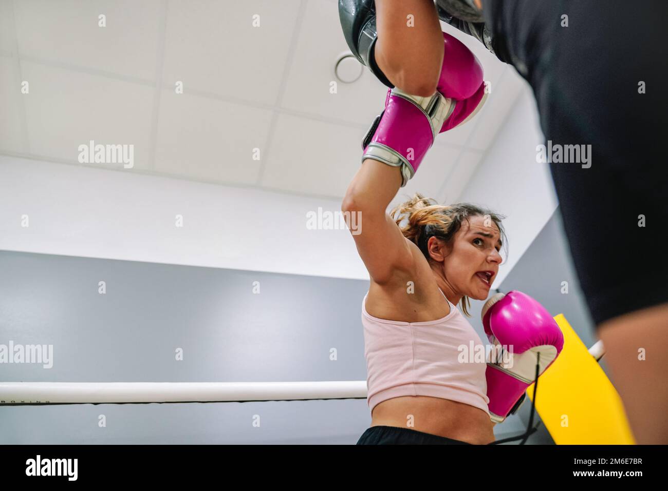 Female boxer throwing a right hand to her opponent in a boxing practice ...