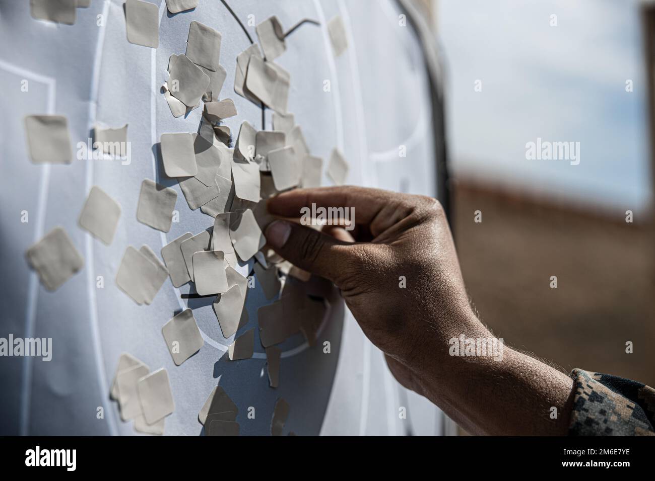 A U.S. Marine with Combat Marksmanship Coach Class 4-22, repairs a ...