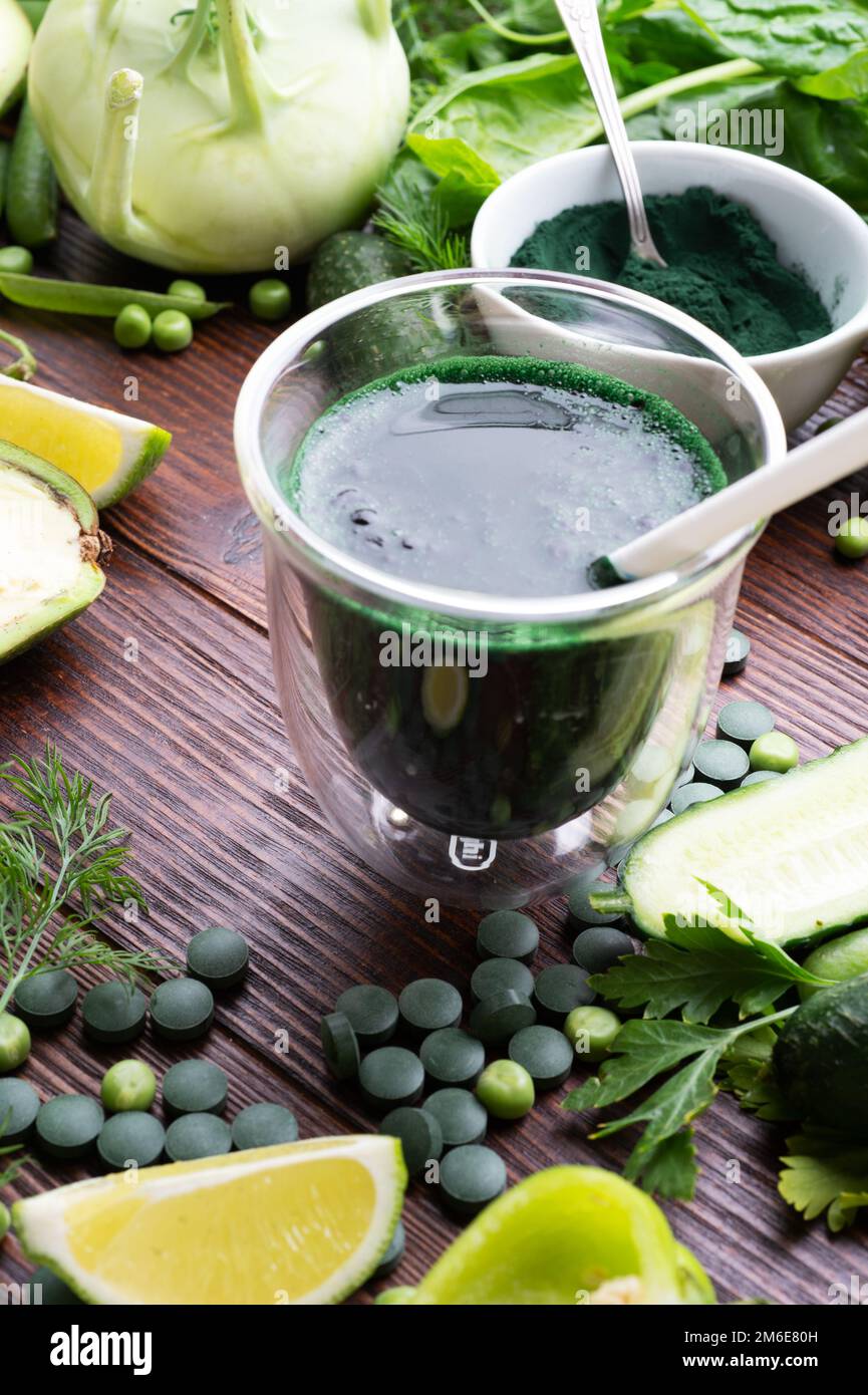 Detox green cocktail with spirulina around vegetables. lifestyle ...