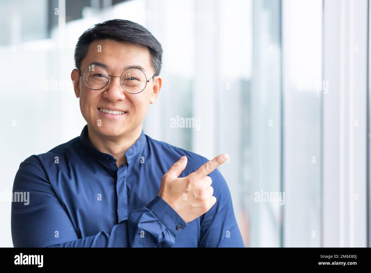 Portrait of happy and successful asian businessman, man smiling and ...