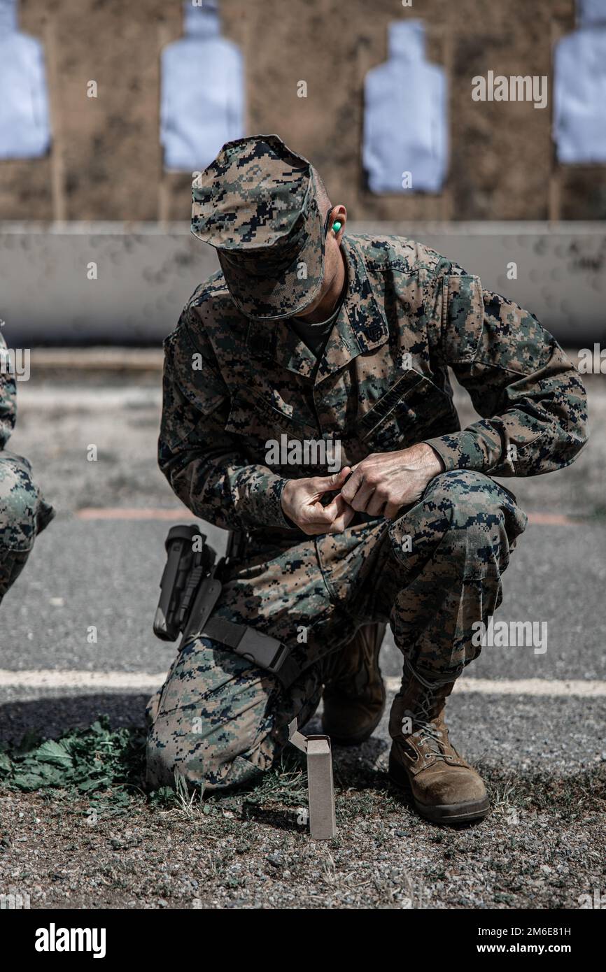 A U.S. Marine with Combat Marksmanship Coach Class 4-22, loads ...