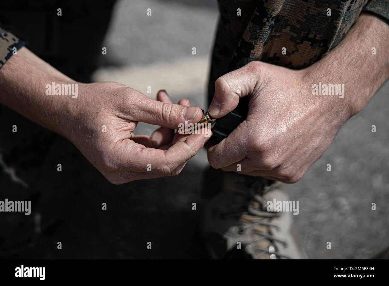 A U.S. Marine with Combat Marksmanship Coach Class 4-22, loads ...