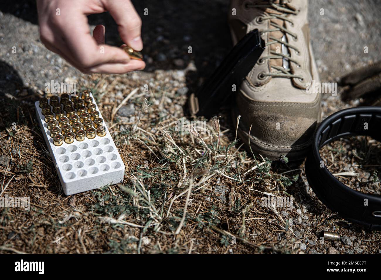 A U.S. Marine with Combat Marksmanship Coach Class 4-22, loads ...