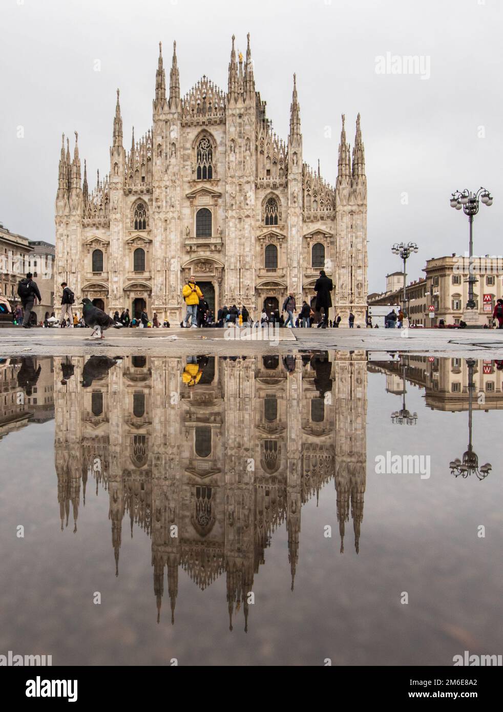 Frequent rainshowers in Milan create waterpools in which Old Town ...
