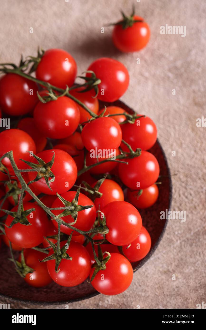 food background with tomatoes on a plate Stock Photo - Alamy