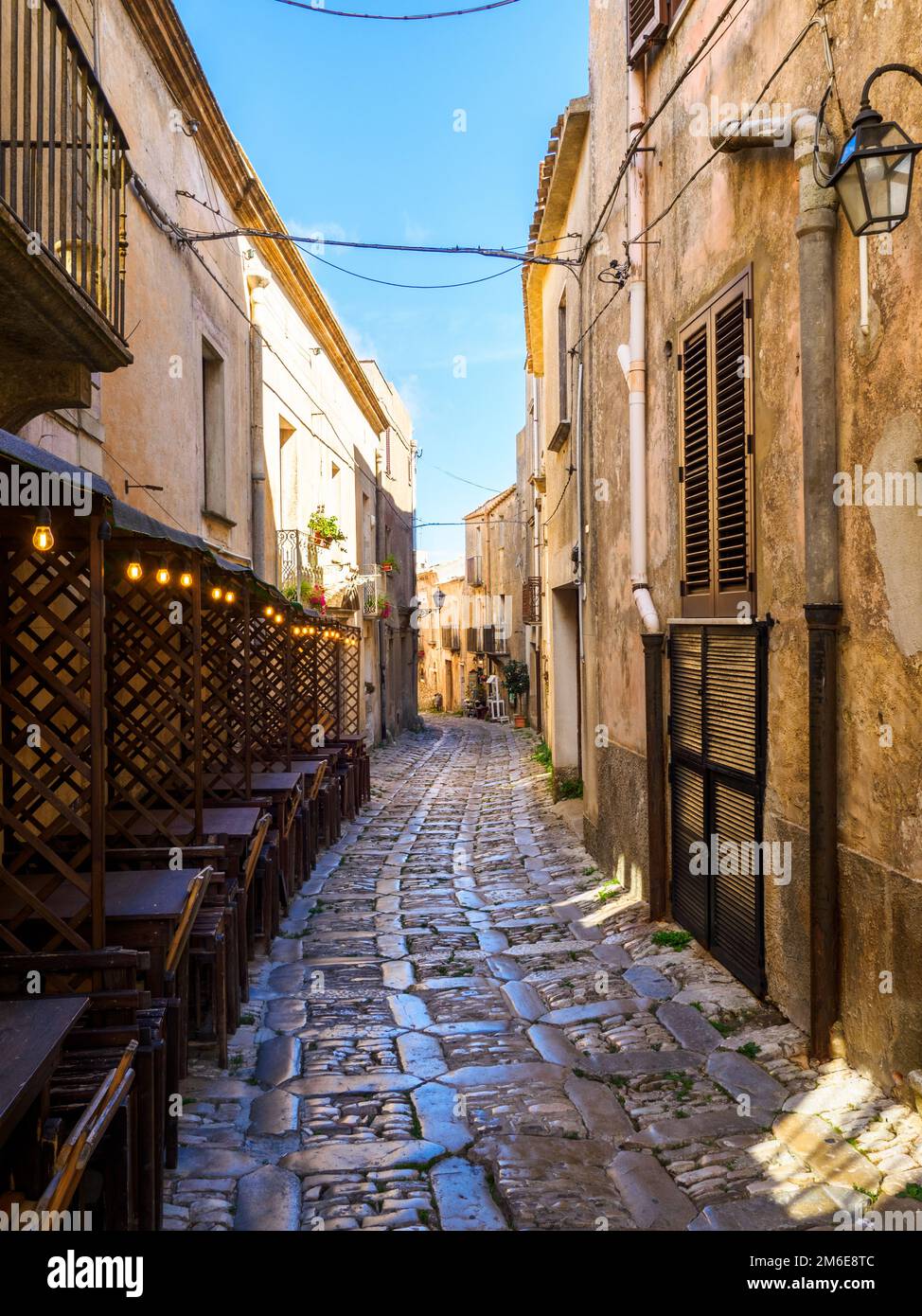 Street with cobblestone pavement in the medieval town of Erice - Sicily ...