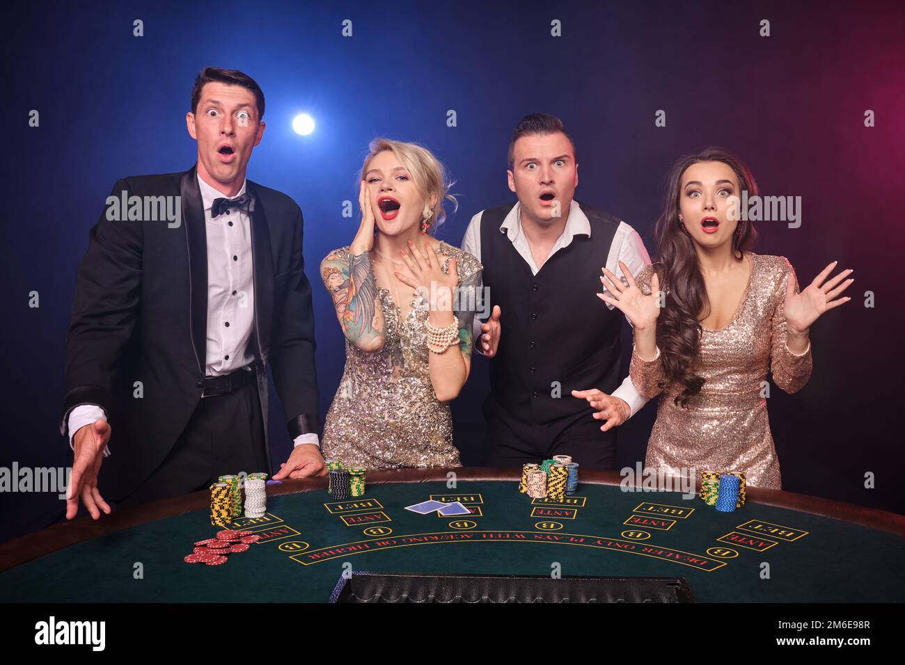 Group of a stylish rich friends are playing poker at casino Stock Photo ...